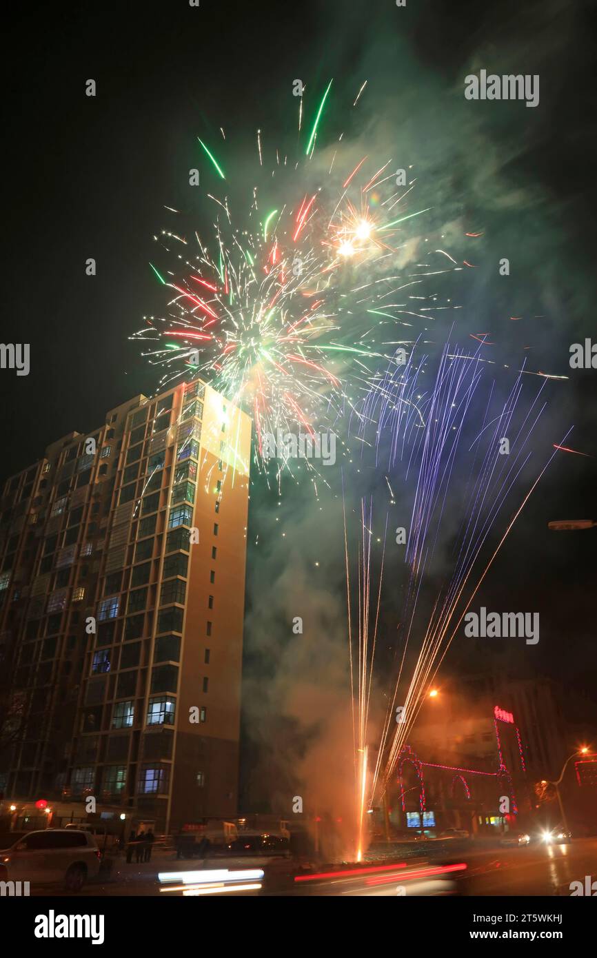 Fireworks over buildings Stock Photo - Alamy