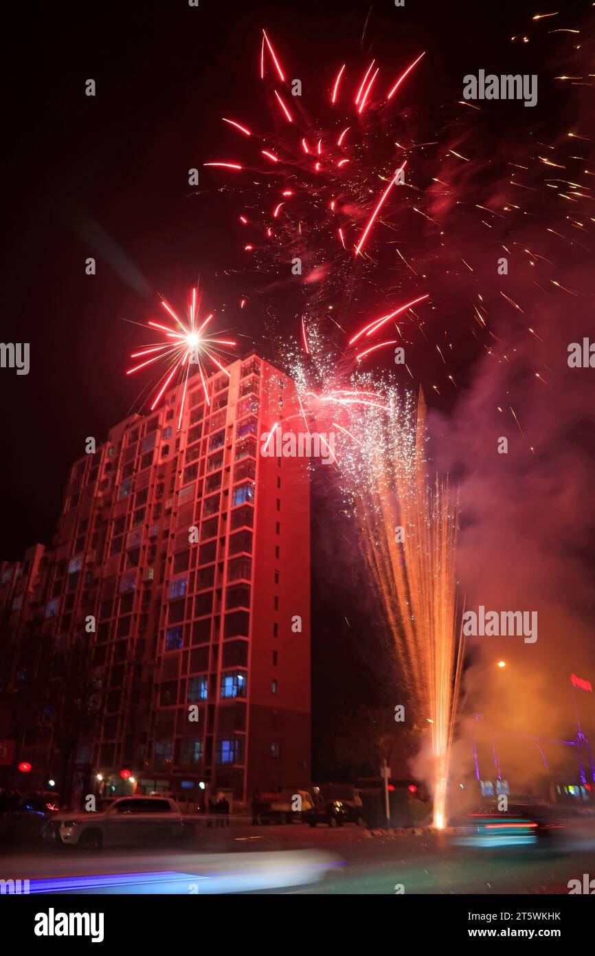 Fireworks over buildings Stock Photo - Alamy