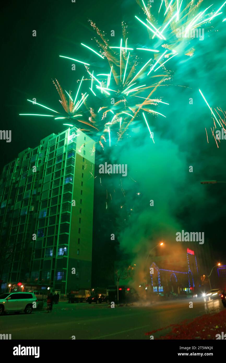Fireworks over buildings Stock Photo - Alamy