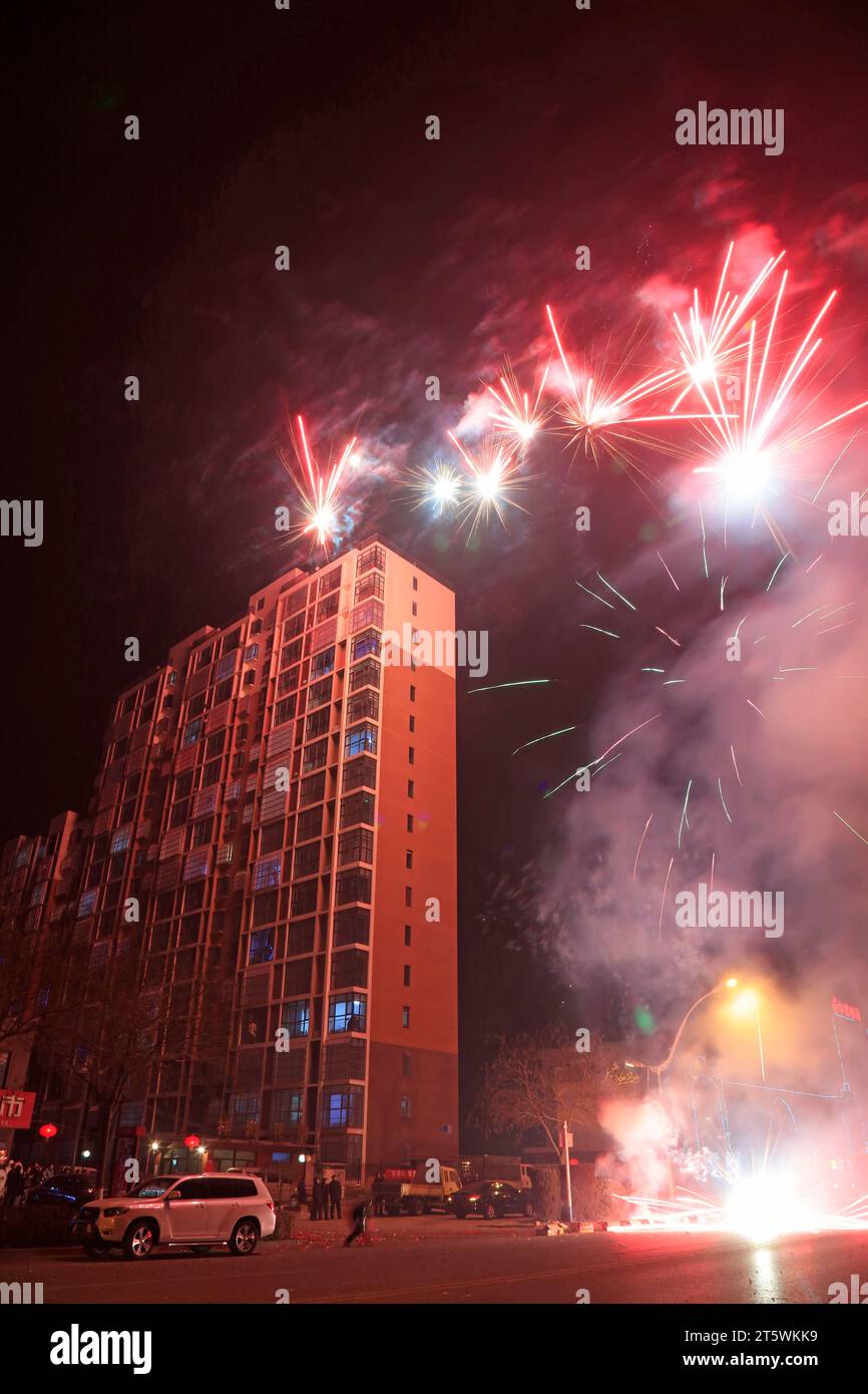 Fireworks over buildings Stock Photo - Alamy