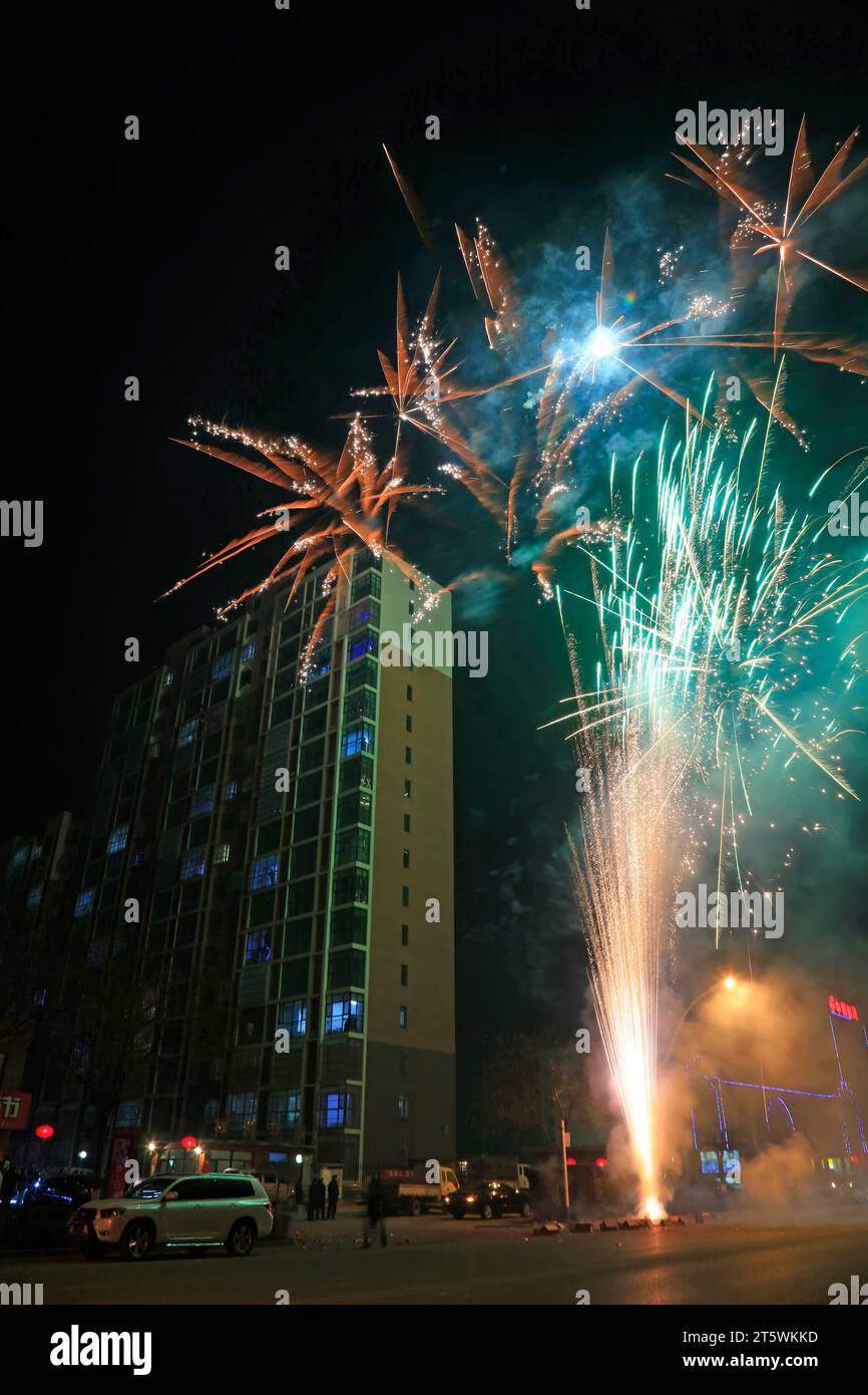Fireworks over buildings Stock Photo - Alamy
