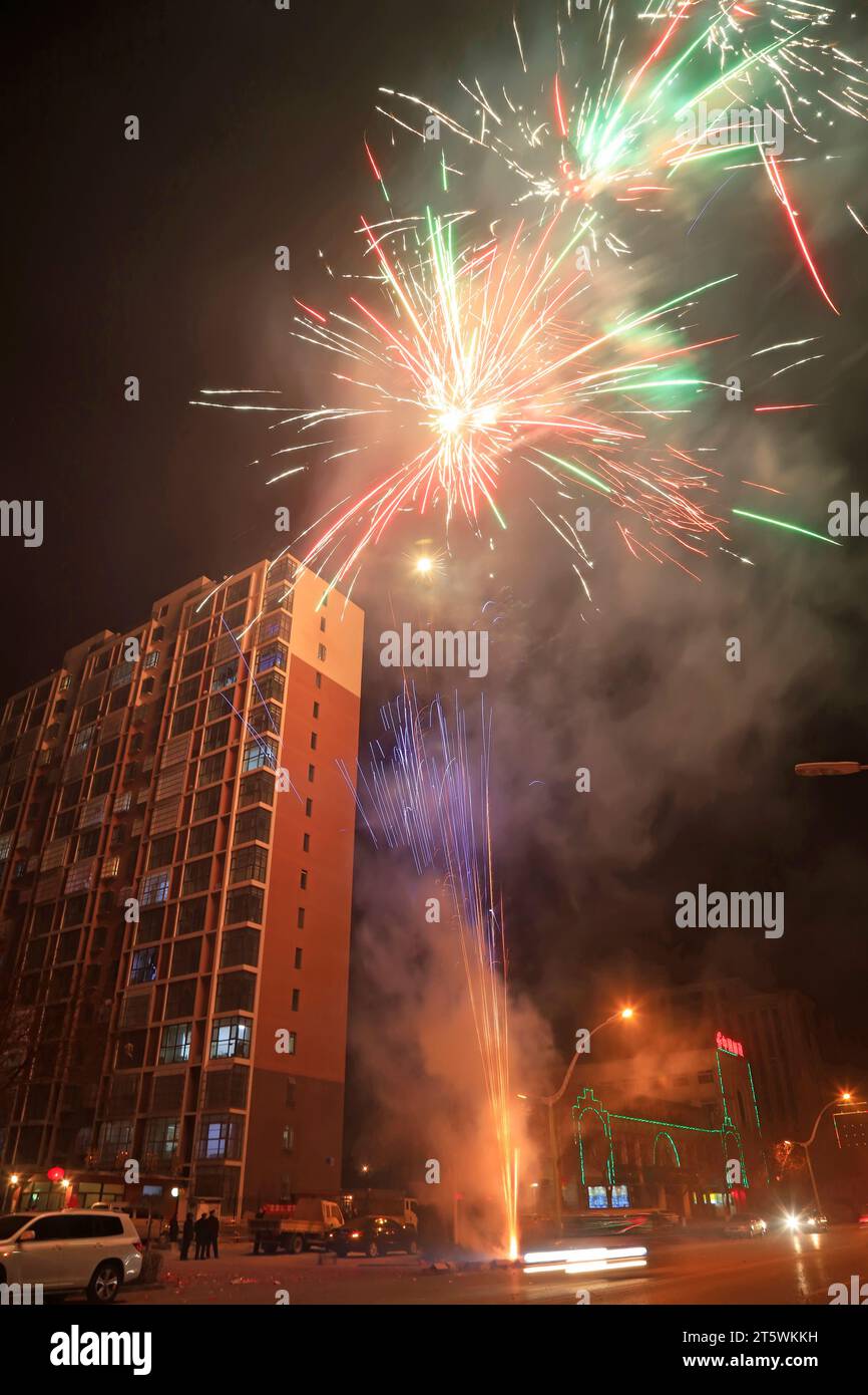 Fireworks over buildings Stock Photo - Alamy