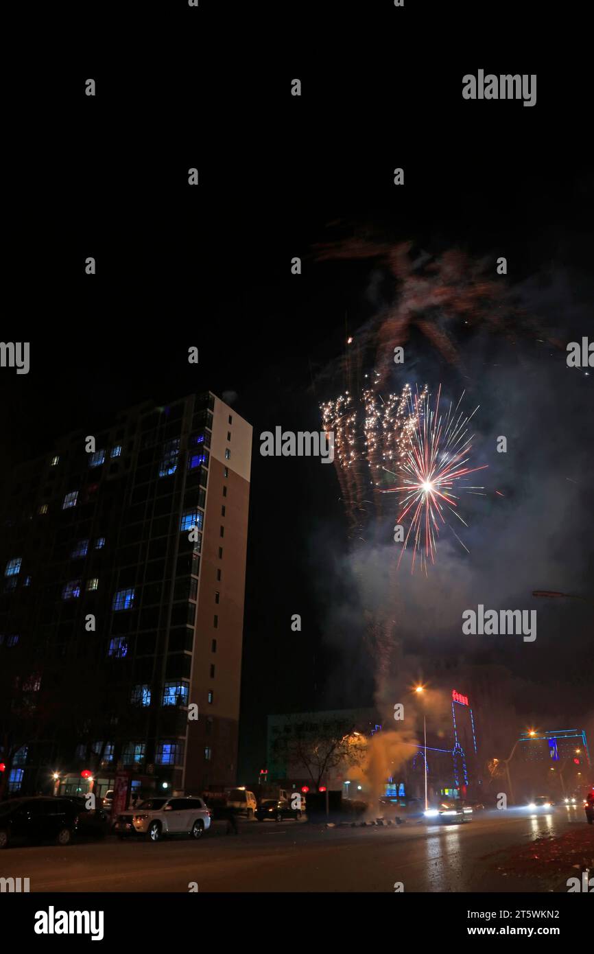 Fireworks over buildings Stock Photo - Alamy