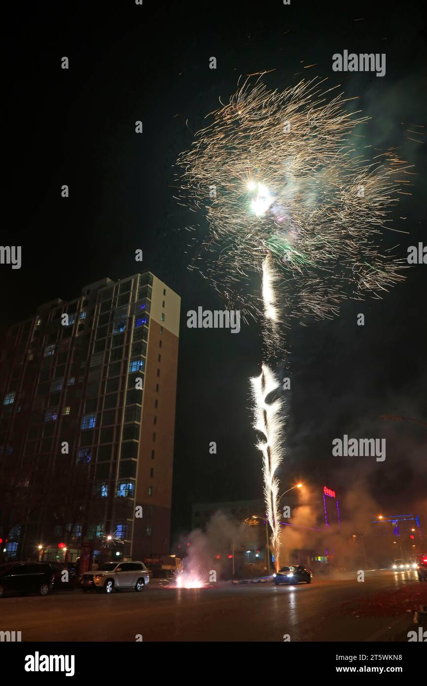 Fireworks over buildings Stock Photo - Alamy