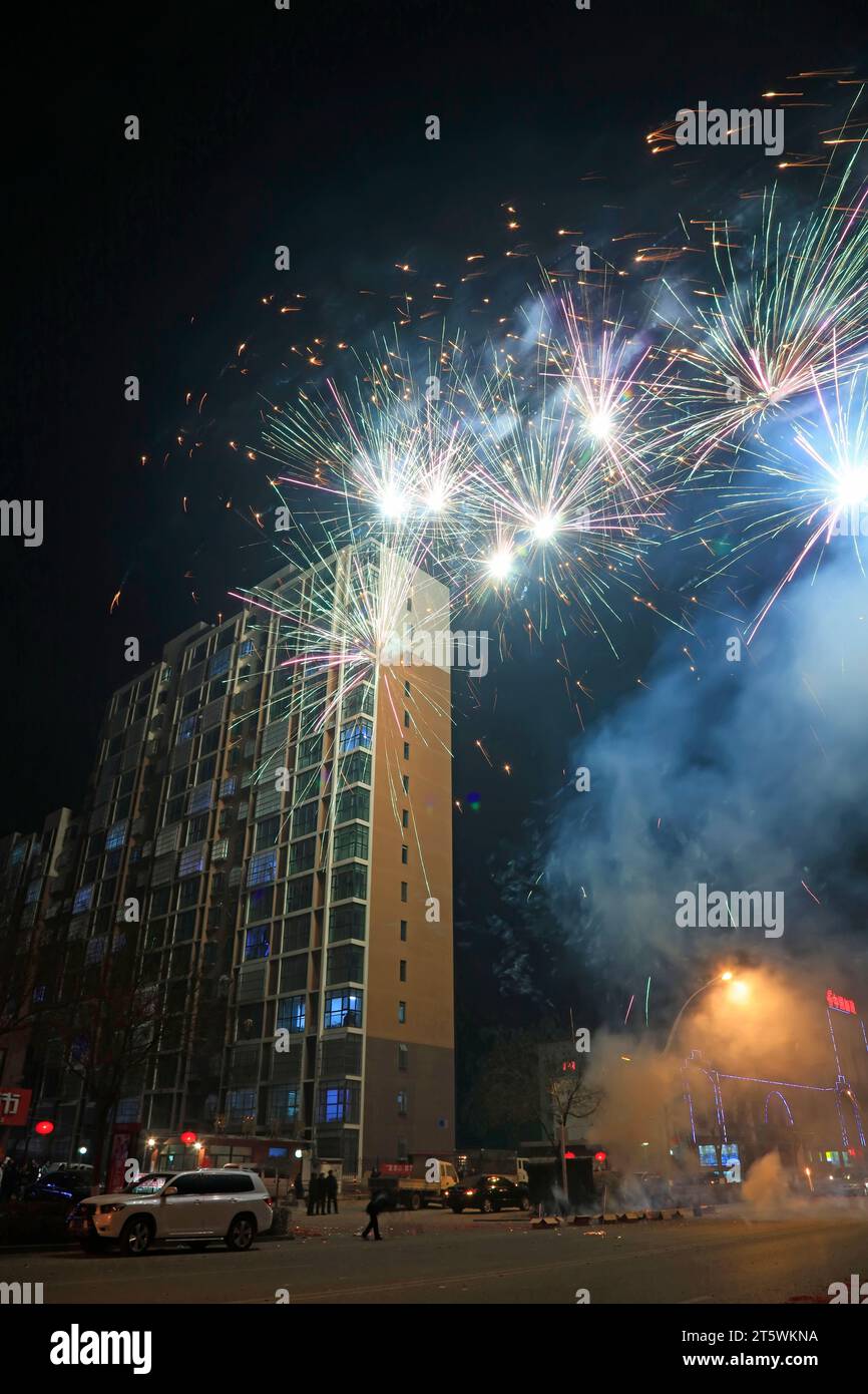 Fireworks over buildings Stock Photo - Alamy