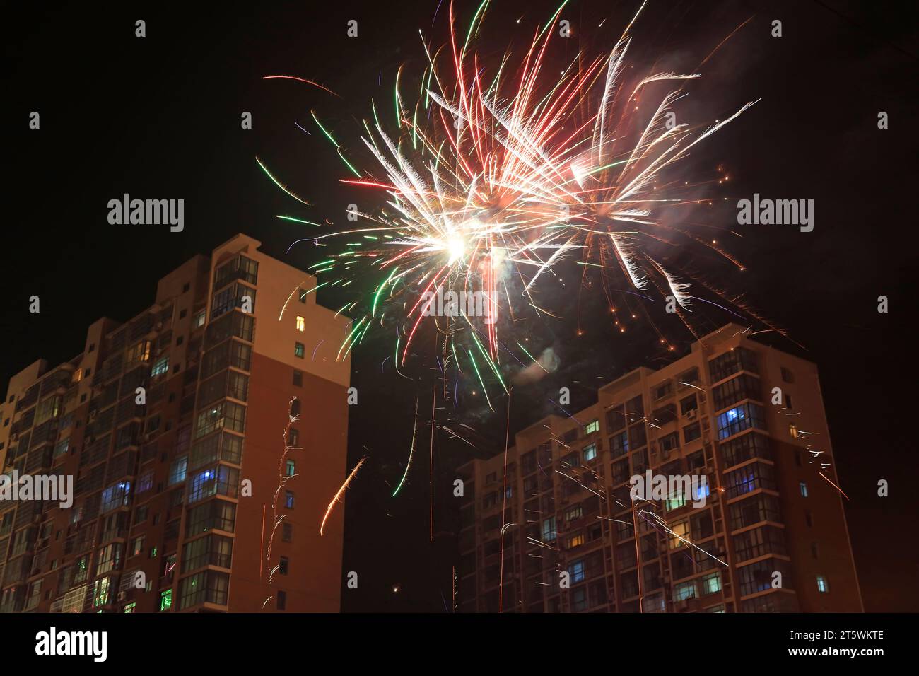 Fireworks over buildings Stock Photo - Alamy