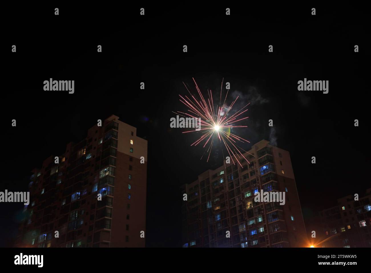 Fireworks over buildings Stock Photo - Alamy