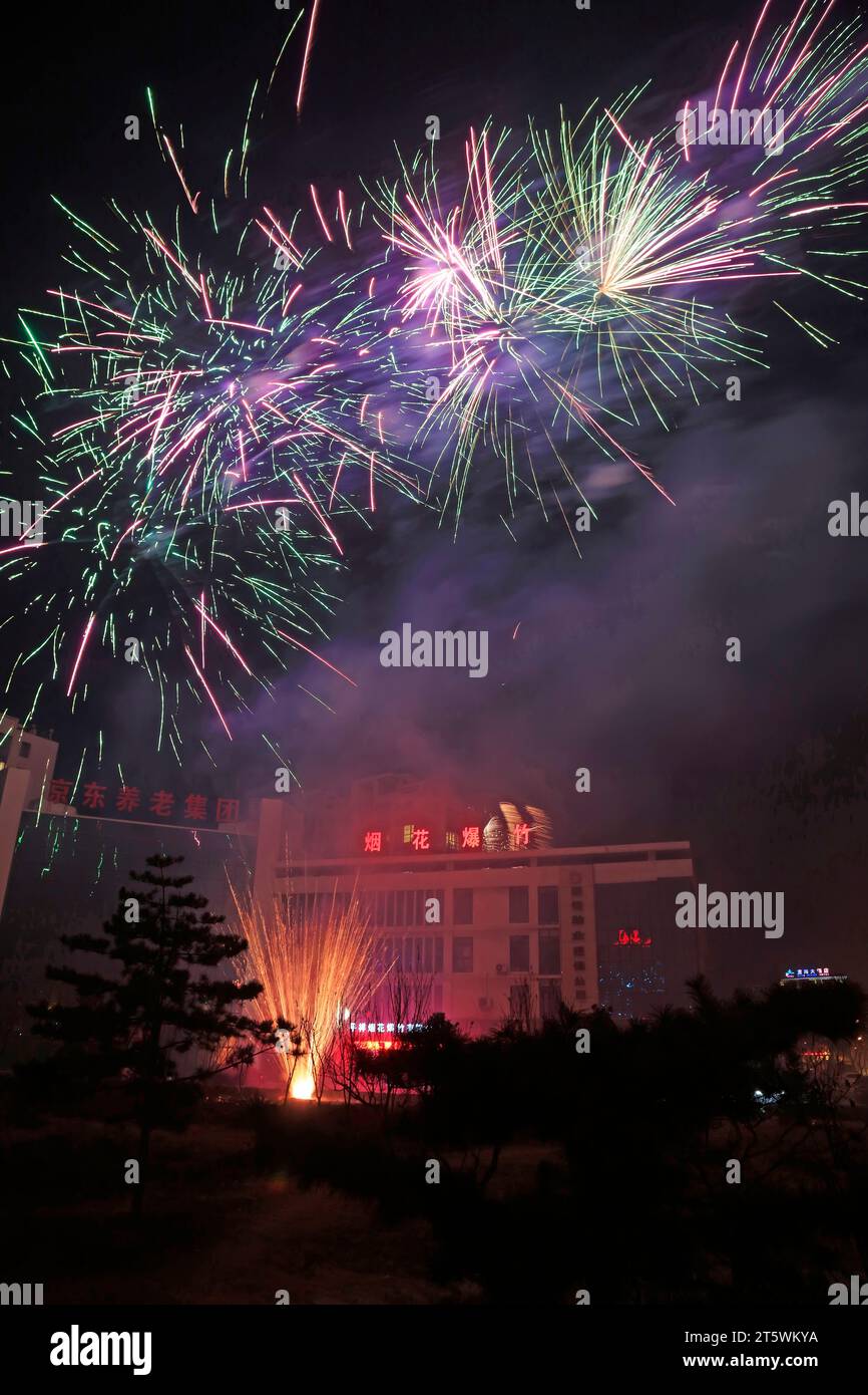 Fireworks over buildings Stock Photo - Alamy