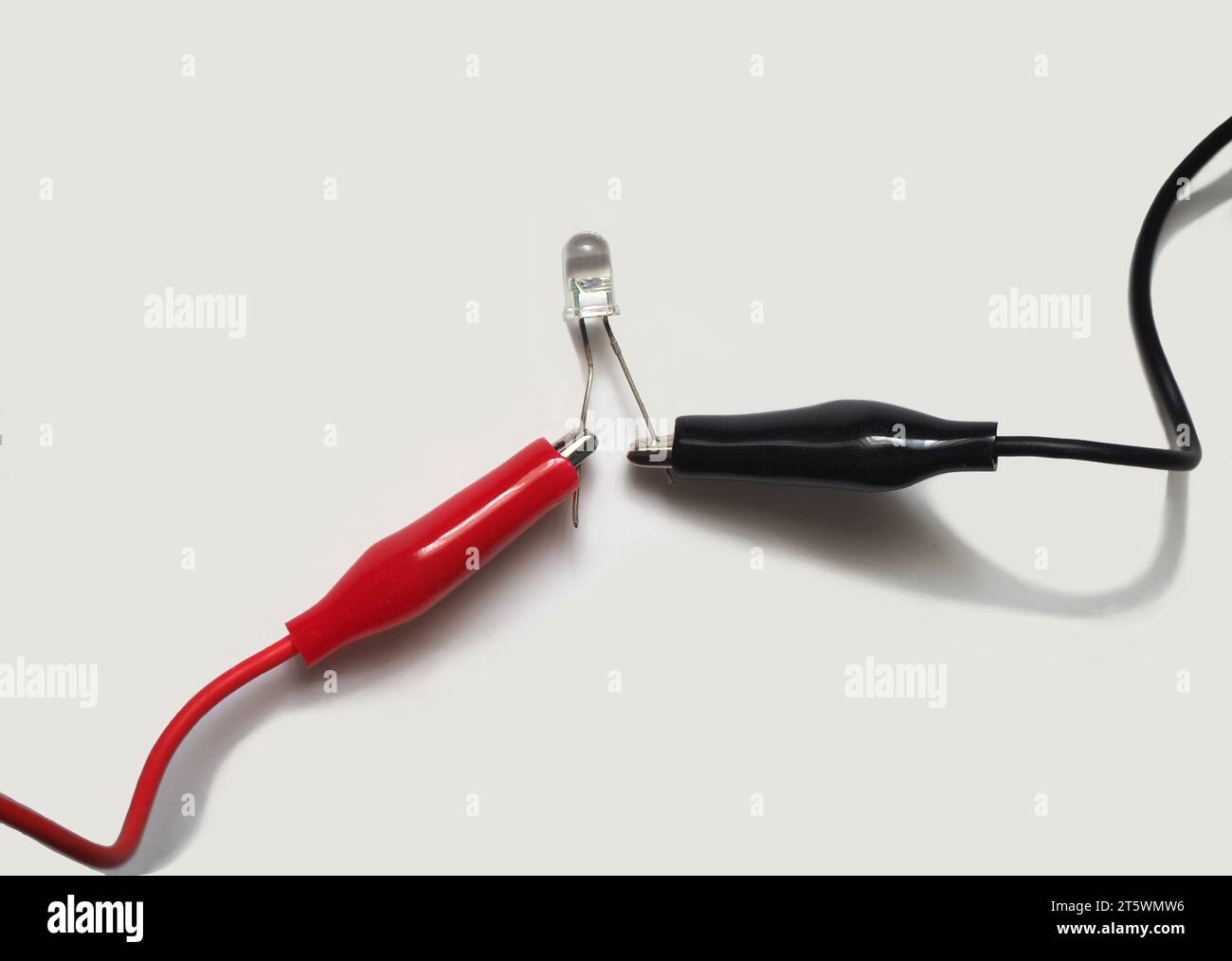 LED attached to red and black wires. Light-emitting diode or LED on a ...