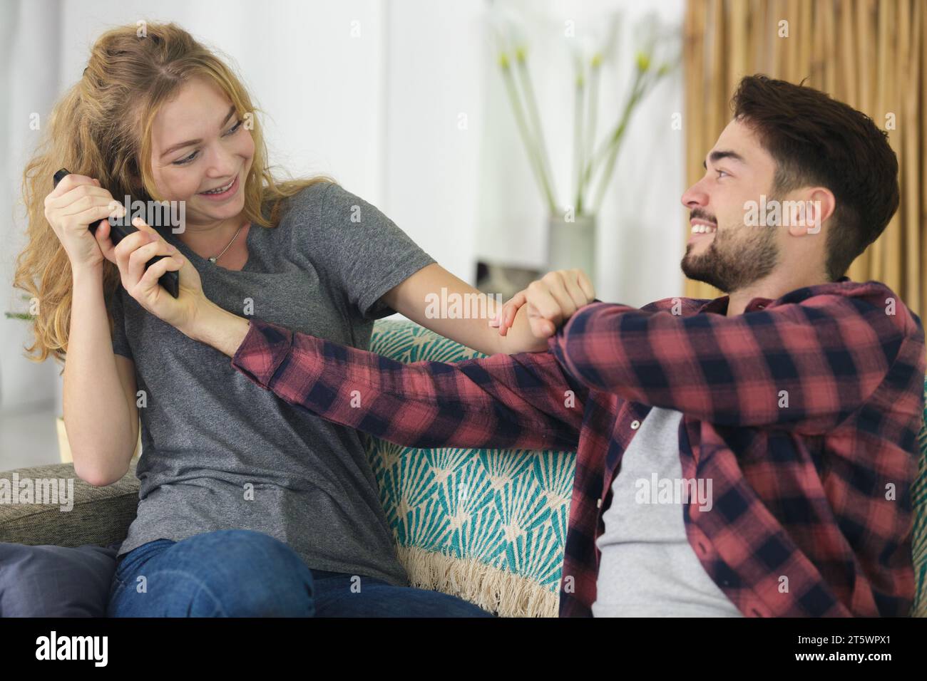 couple tagging over remote control Stock Photo - Alamy