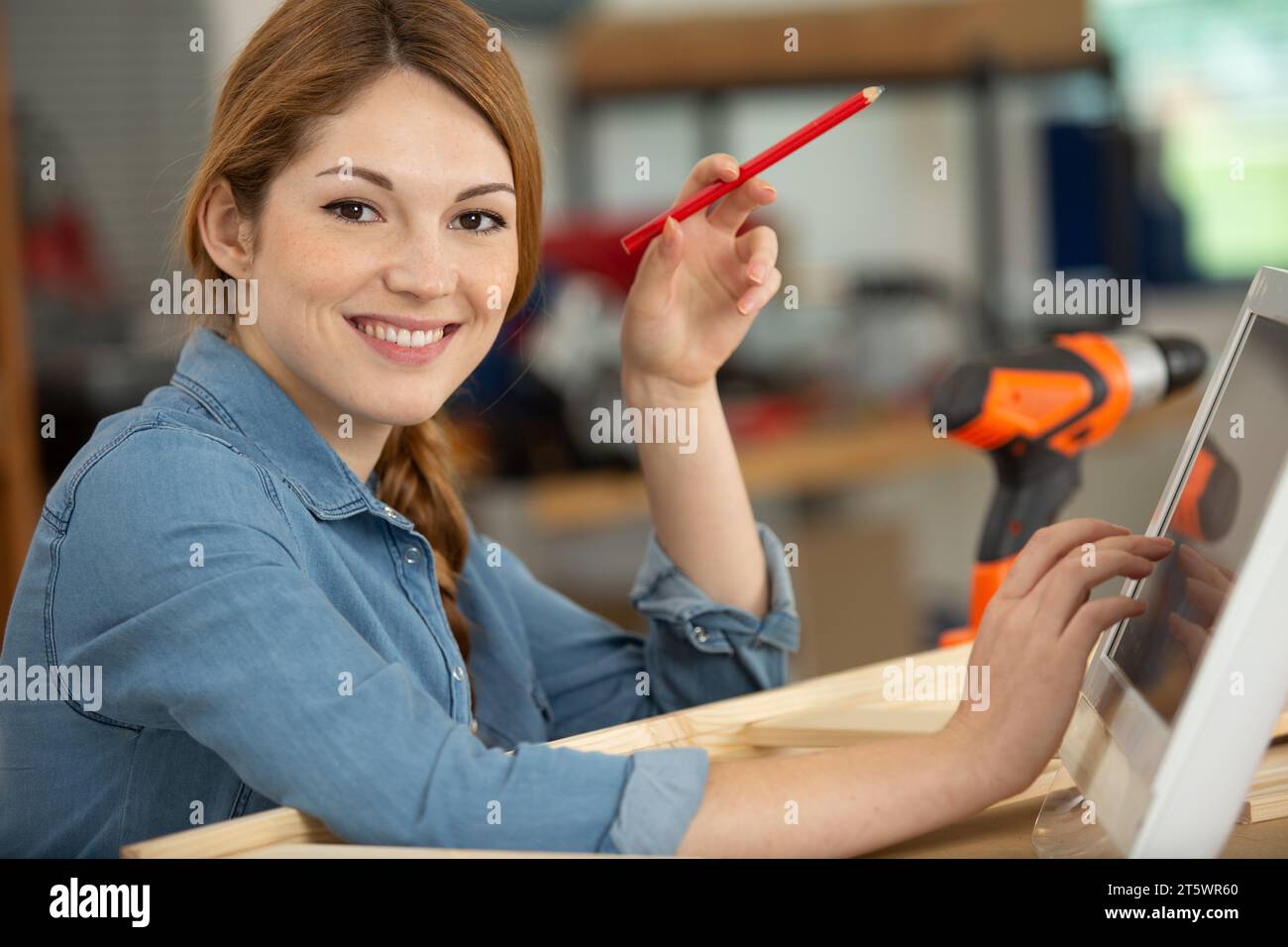 happy woman using hand drilling machine Stock Photo - Alamy