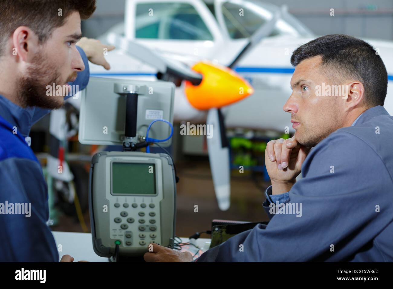 aircraft maintenance mechanic inspects plane chassis Stock Photo - Alamy