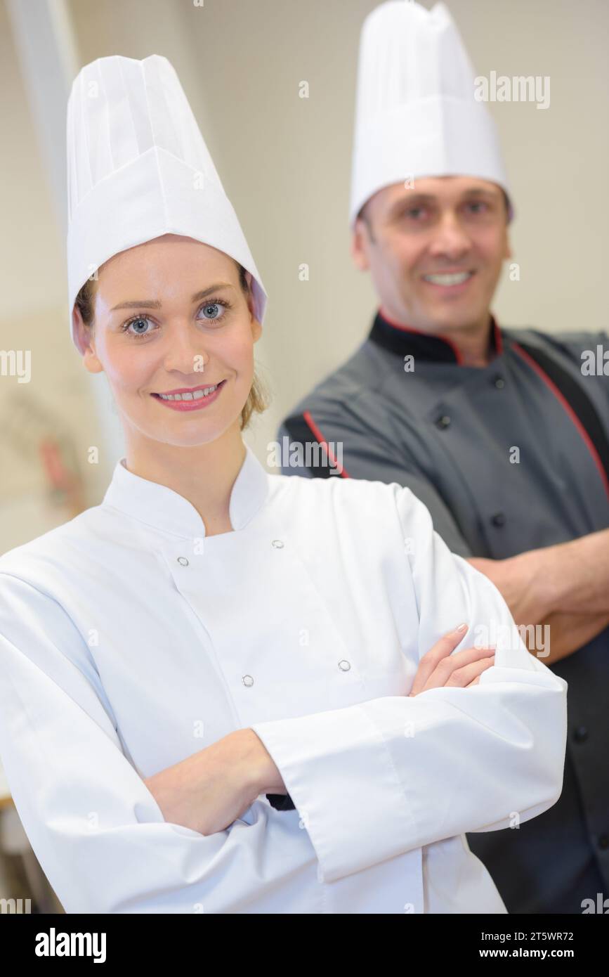 two smiling chefs in kitchen Stock Photo - Alamy
