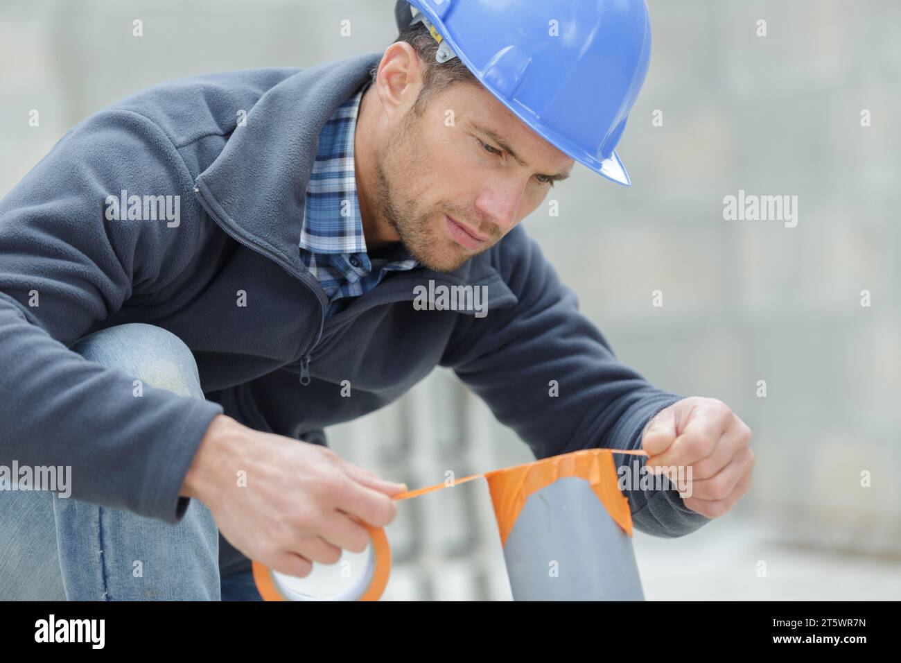 man digging out clogged sewer line closeup Stock Photo - Alamy