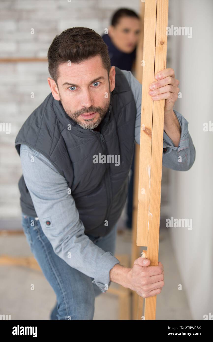construction man is shifting wood Stock Photo - Alamy