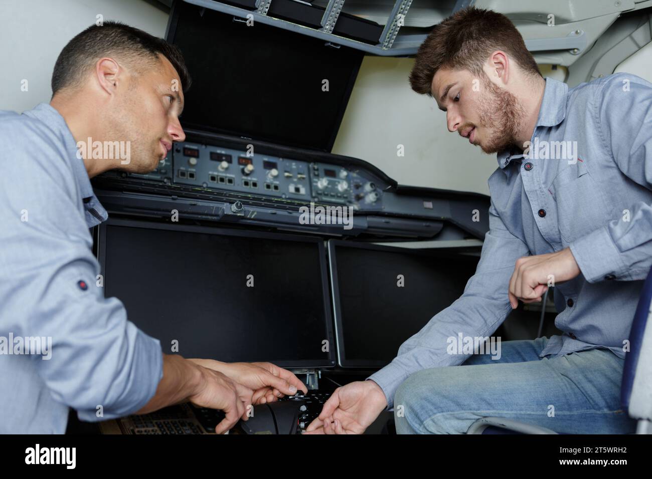 portrait of apprentice inside airplane cabin Stock Photo - Alamy
