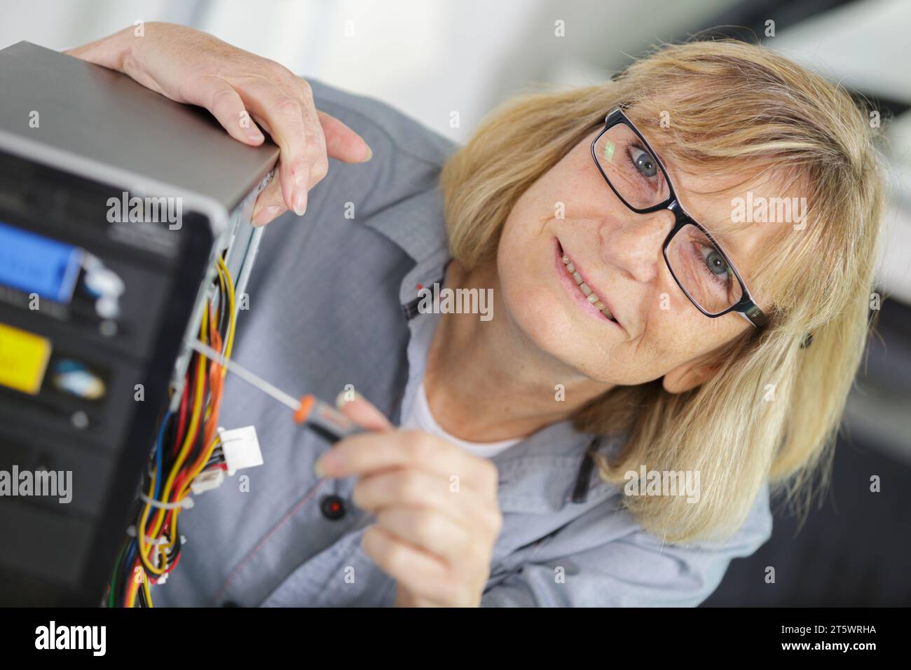 mature woman using screw driver fix pc Stock Photo - Alamy