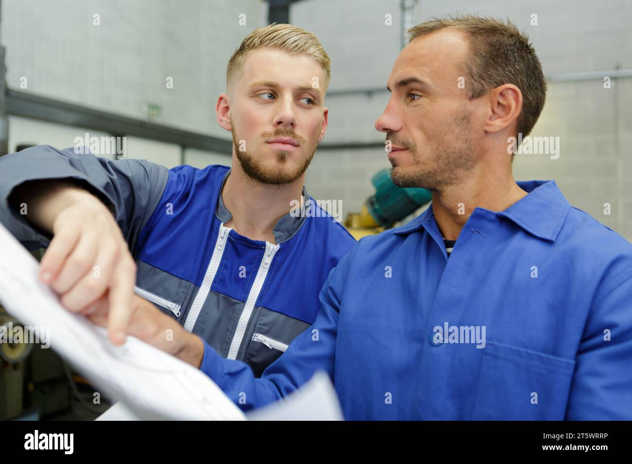 two mechanics work with the details of the car Stock Photo - Alamy
