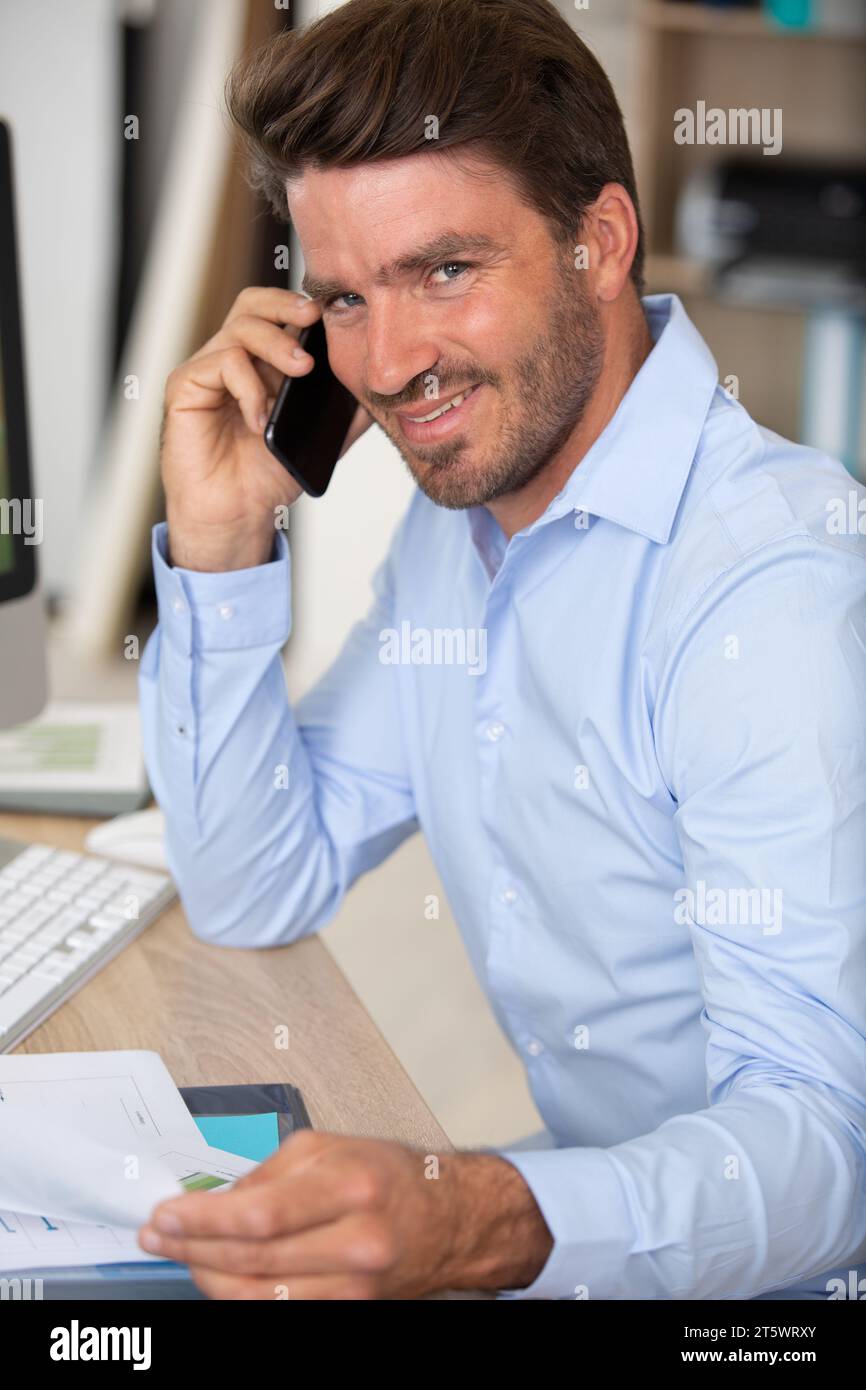 office worker calling on the phone and reading business document Stock ...