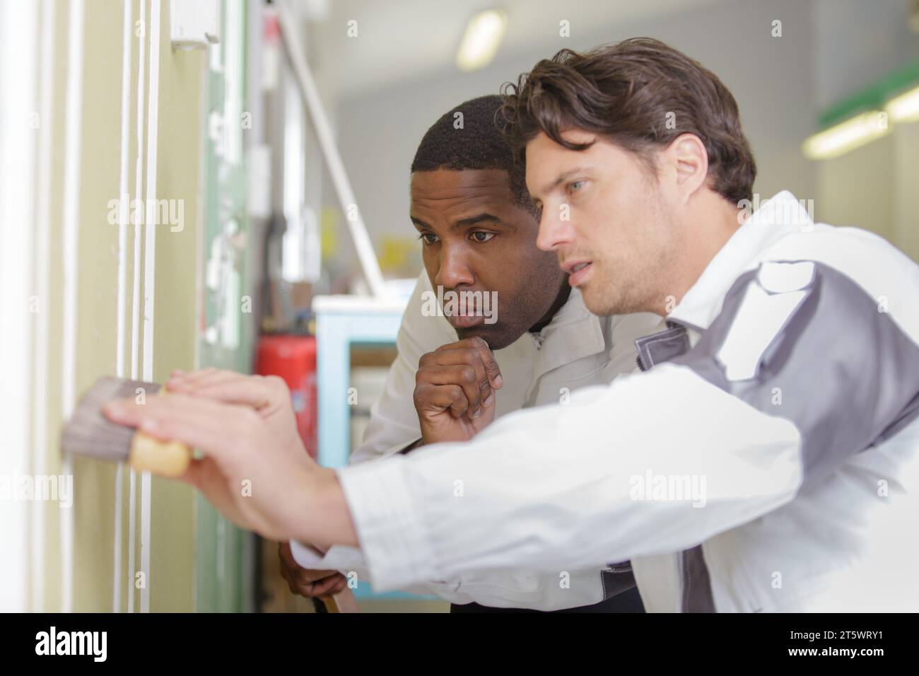 foreman showing apprentice how to use plaster and trowel Stock Photo ... foreman showing apprentice how to use plaster and trowel Stock Photo ...