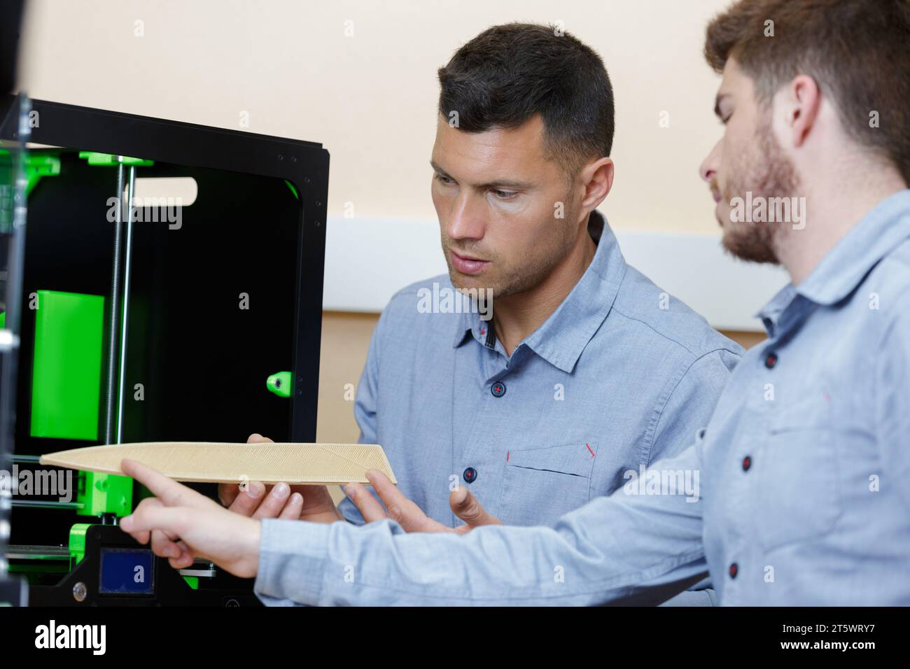 professional designer and student standing next to 3d printer Stock ...