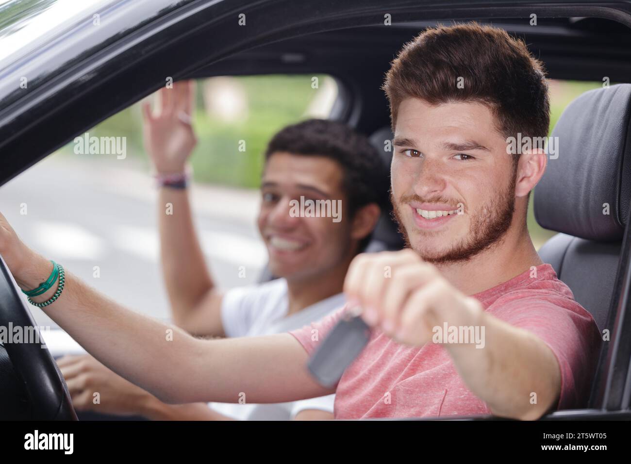 young man driving behind the wheel of the car Stock Photo - Alamy