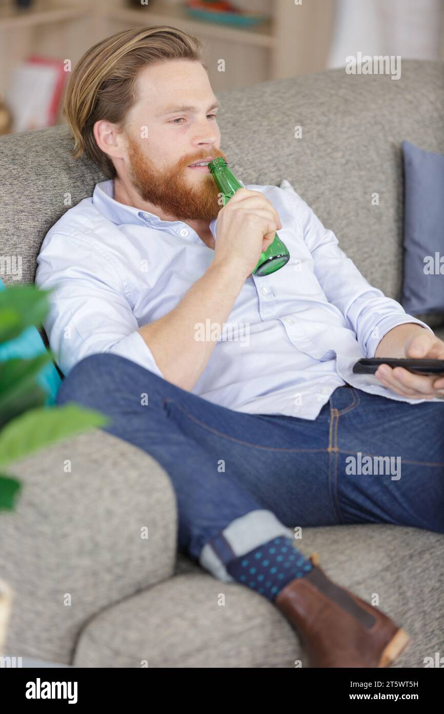 Man lazing on sofa hi-res stock photography and images - Alamy