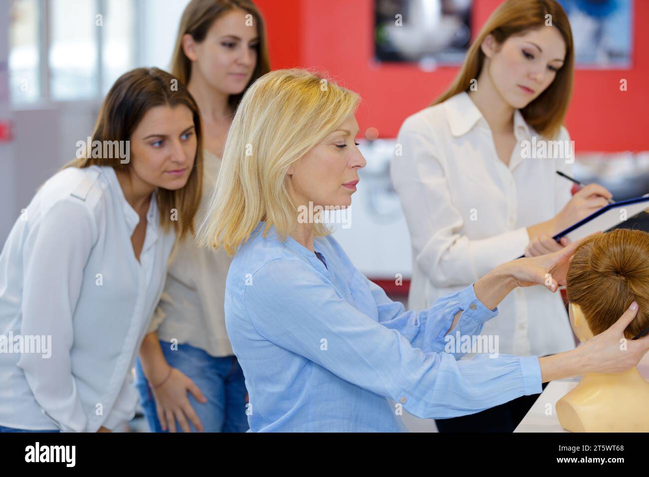 teacher model and students in hairdressing Stock Photo - Alamy