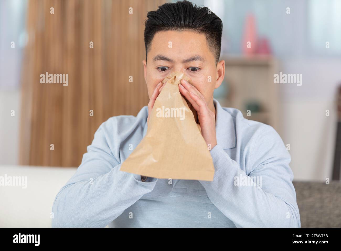 Man Breathing Into Paper Bag