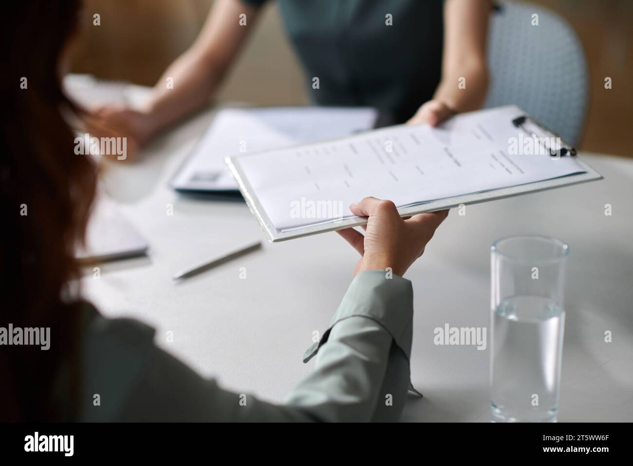 Employee giving filled labor contract to HR manager Stock Photo - Alamy