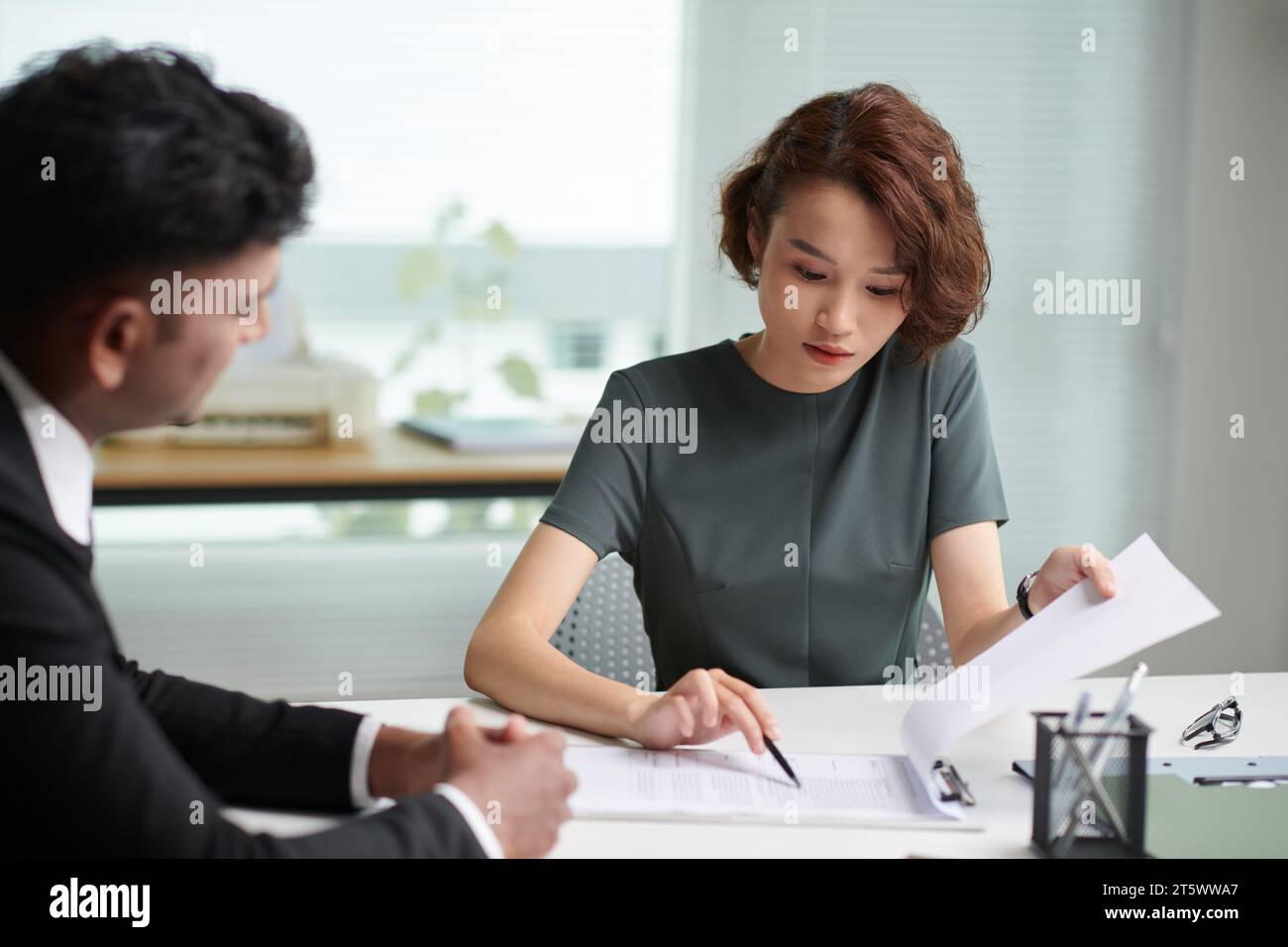 Manager asking new employee to fill application form Stock Photo - Alamy