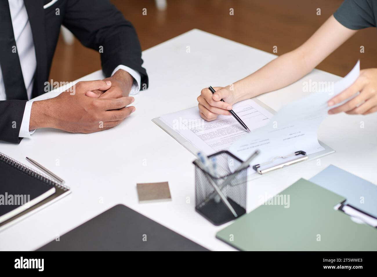 Human resources manager asking employee to fill application form Stock ...