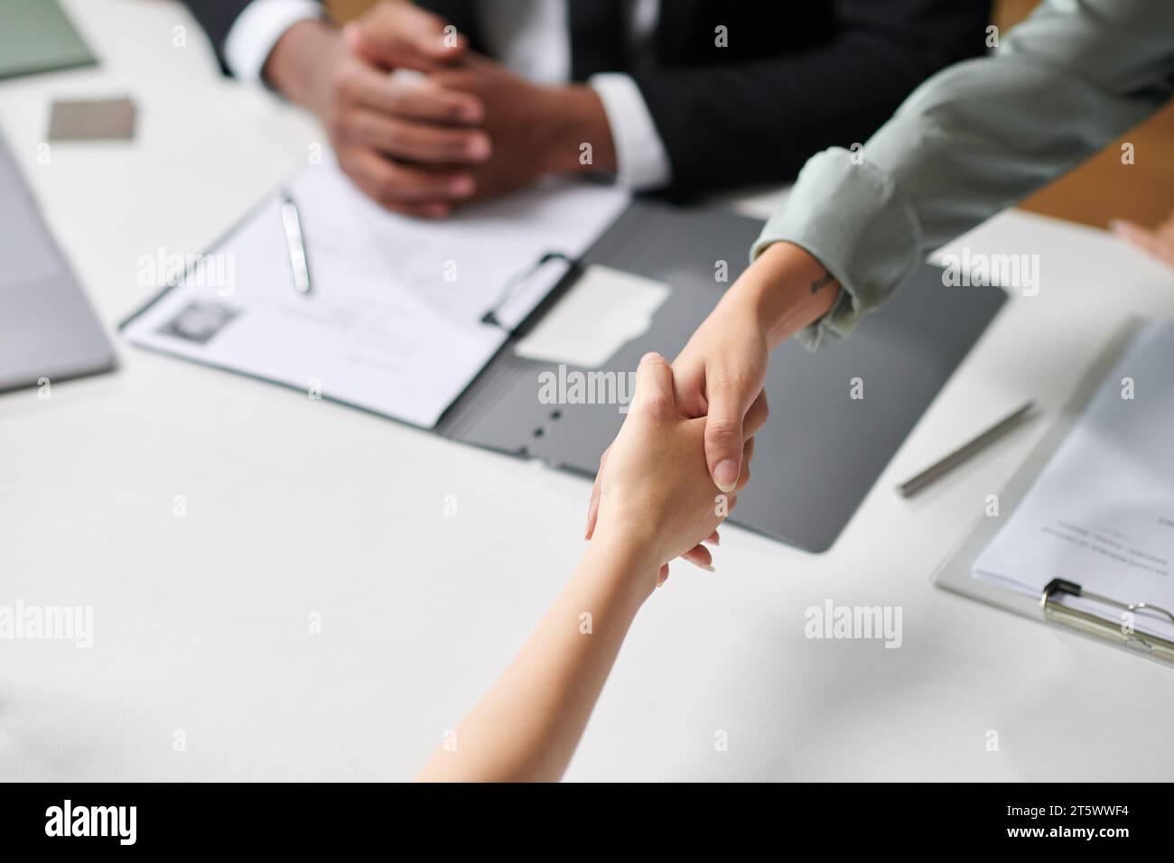 Company managers greeting new employee, shaking her hand Stock Photo ...