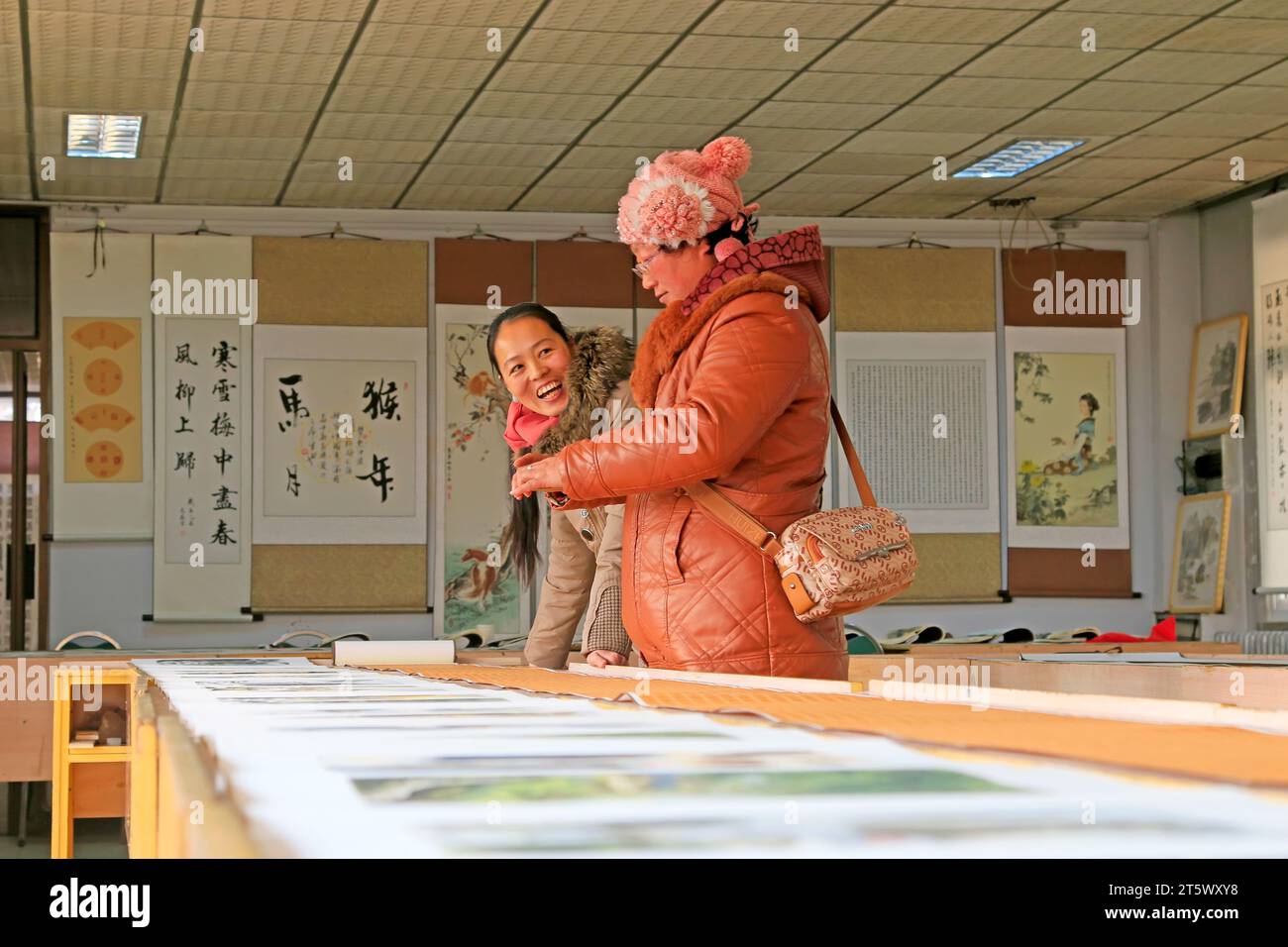Tangshan City - February 22, 2016: a lady takes pictures of paintings ...