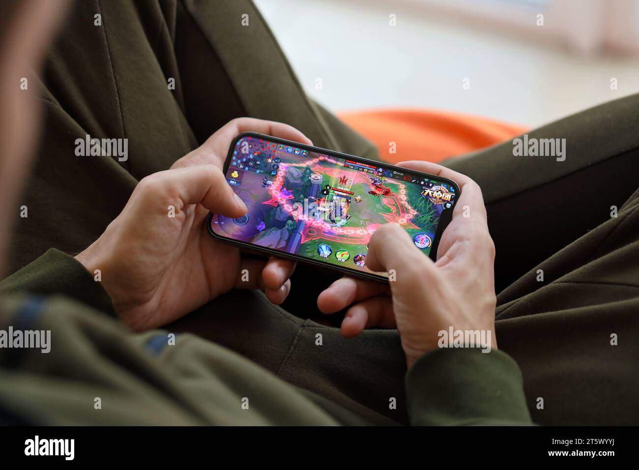 Honor of Kings mobile iOS game on iPhone 15 smartphone screen in male ...