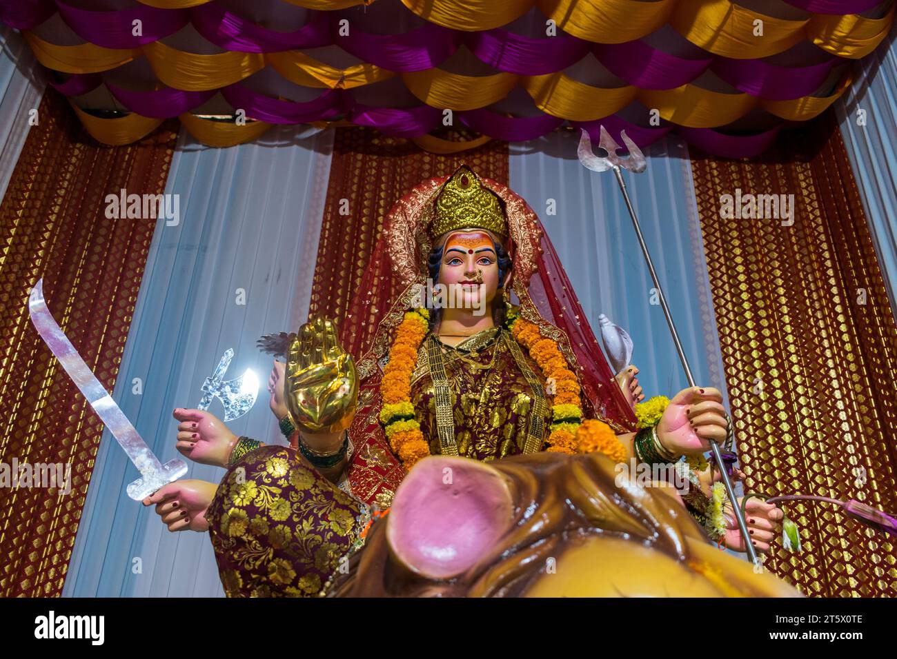 A beautiful idol of Maa Durga being worshipped at a pandal during ...