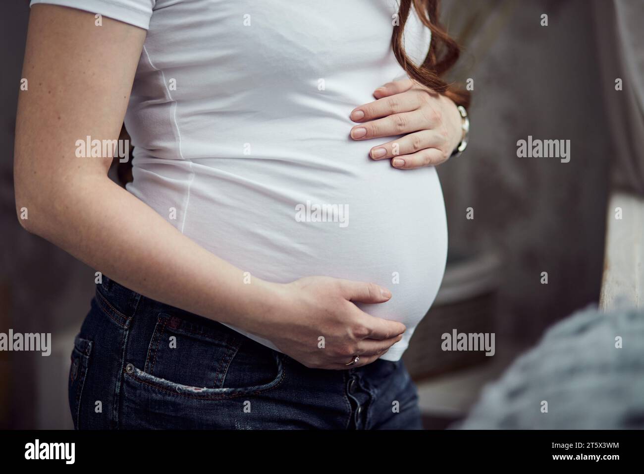 Beautiful pregnant woman hugging her belly. Expectant mother waiting ...