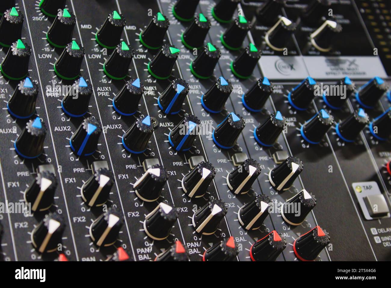 Close-up shot of rows of control knobs and buttons on a digital multi ...
