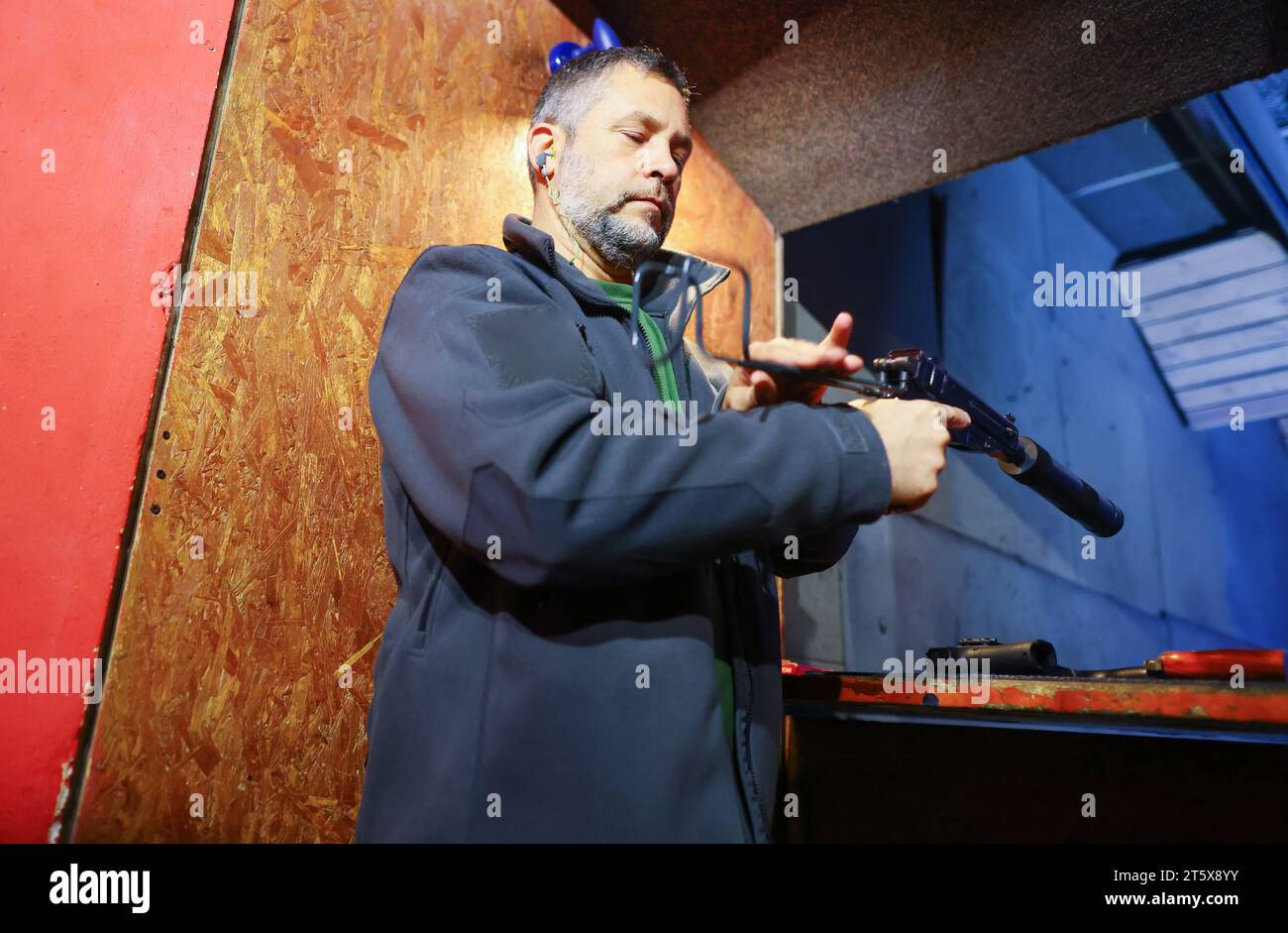 Man with pistol at firing range Stock Photo - Alamy