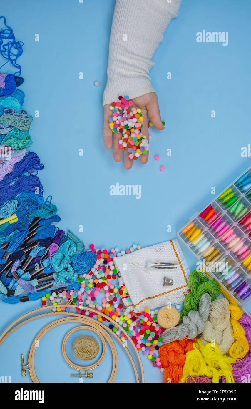 Crop beautiful happy girl with hoop and threads embroidering in ...