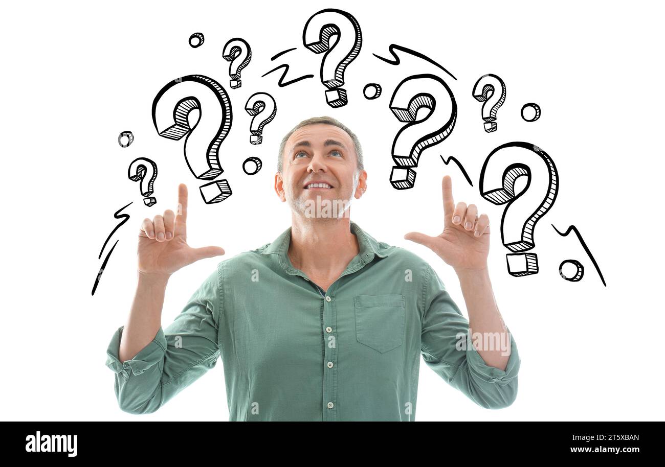 Portrait of mature man pointing at many question marks on white ...