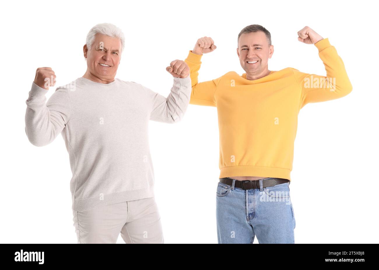 Mature brothers showing muscles on white background Stock Photo - Alamy