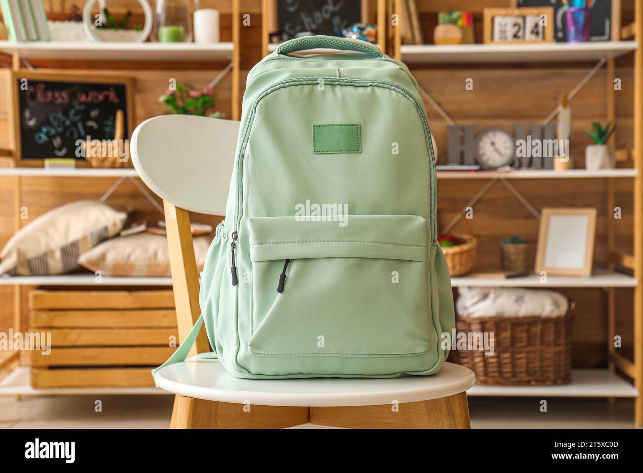 Stylish school backpack on chair in room Stock Photo - Alamy