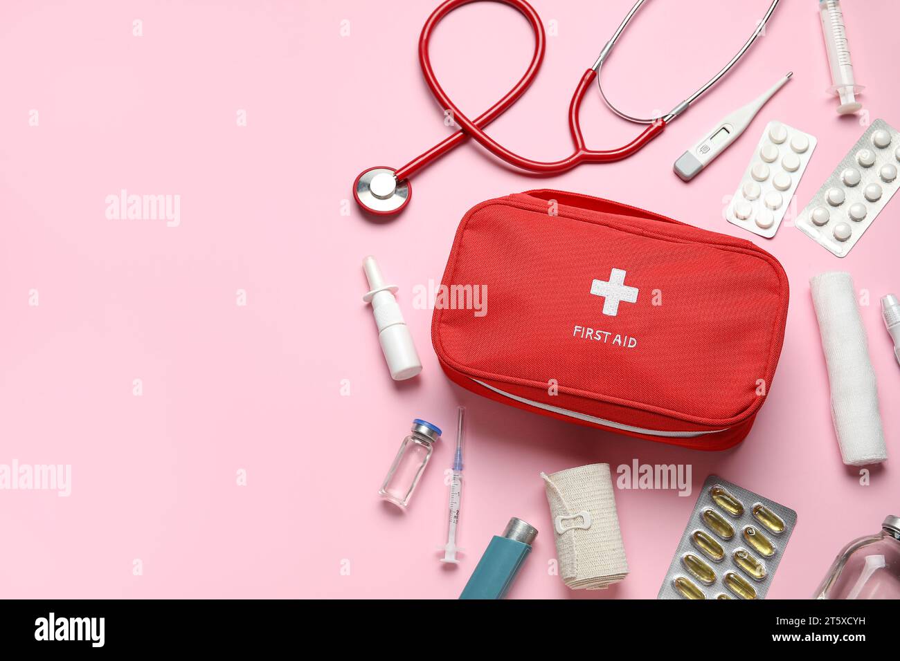 First aid kit and pills on pink background Stock Photo - Alamy