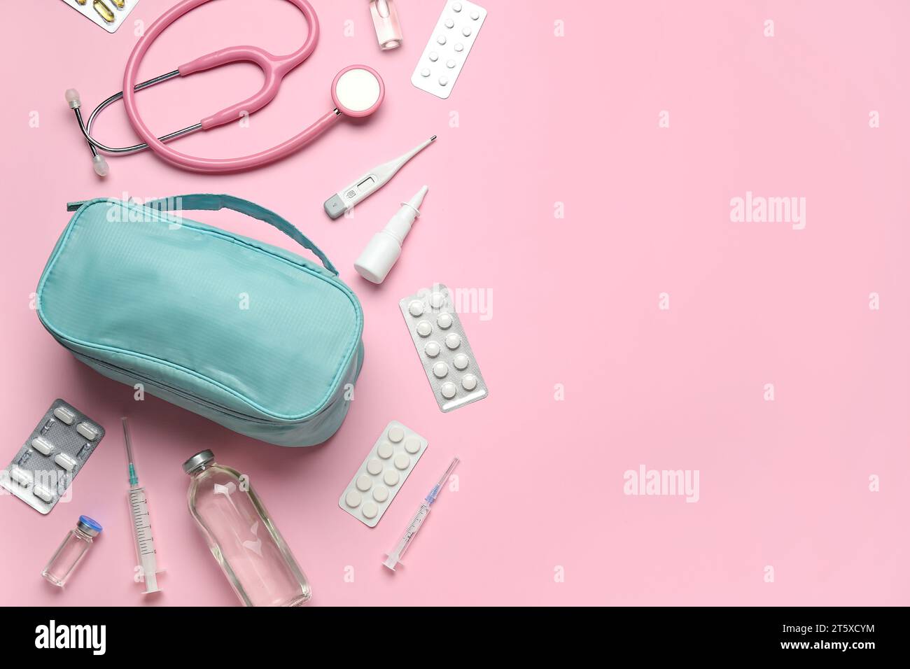First aid kit and pills on pink background Stock Photo - Alamy