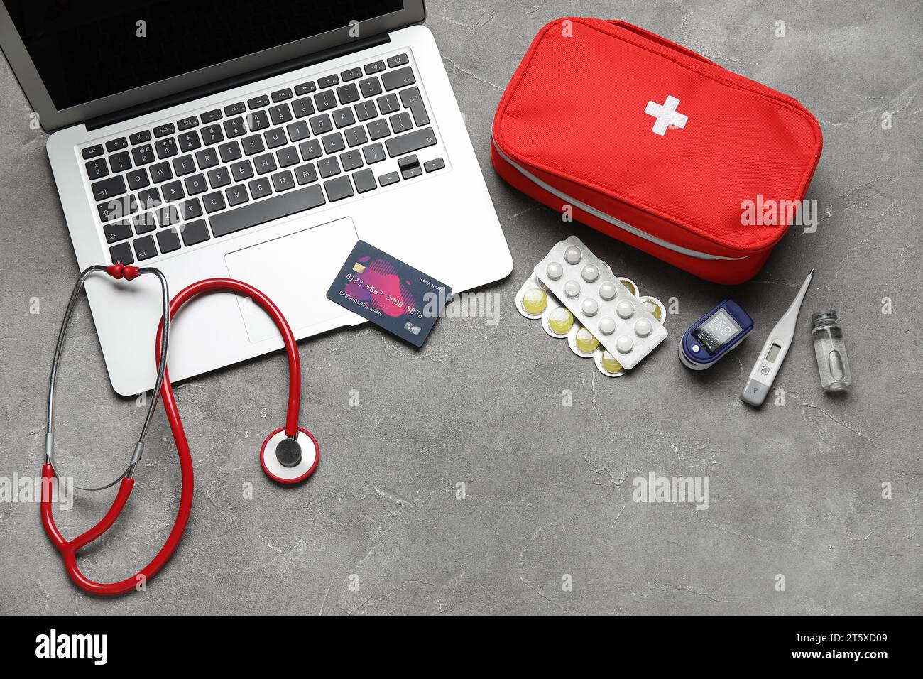 Laptop, credit card and first aid kit on grey background Stock Photo ...