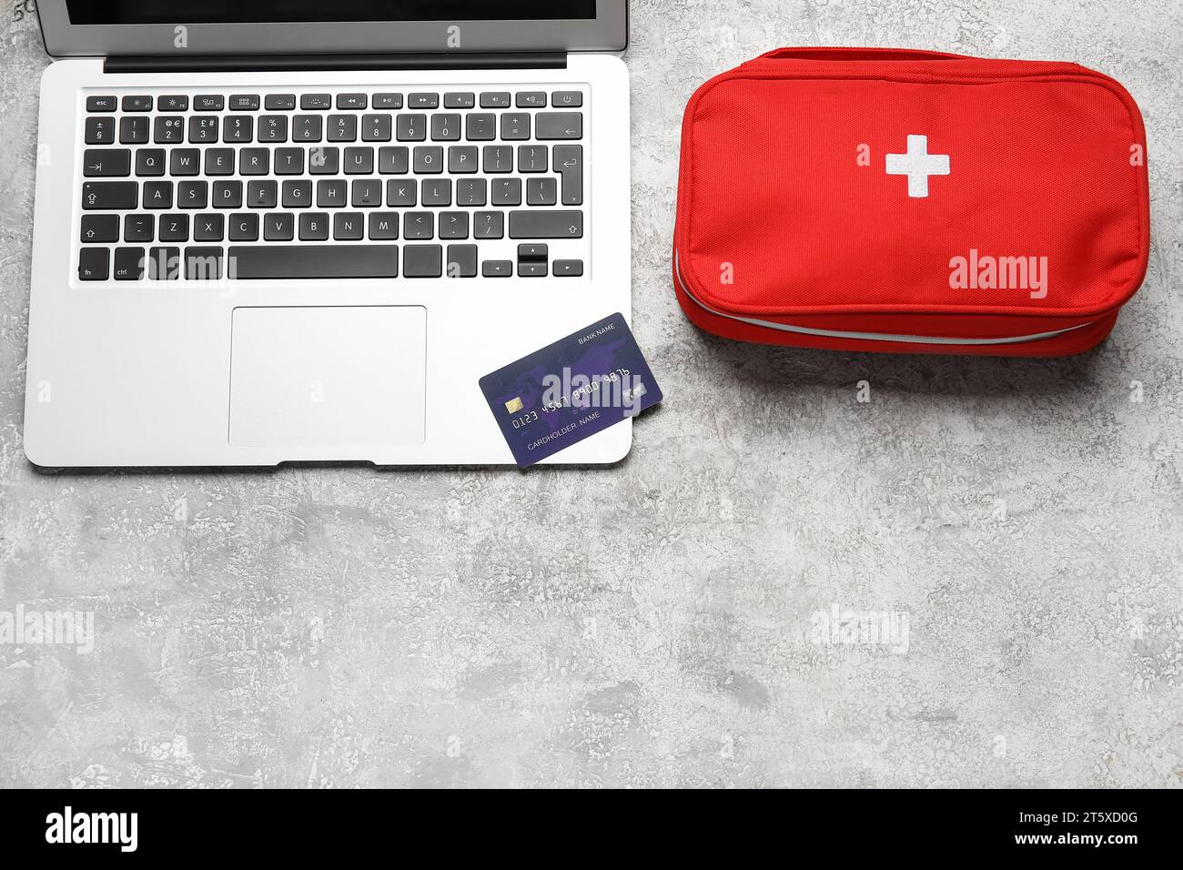 Laptop, credit card and first aid kit on grunge grey background Stock ...
