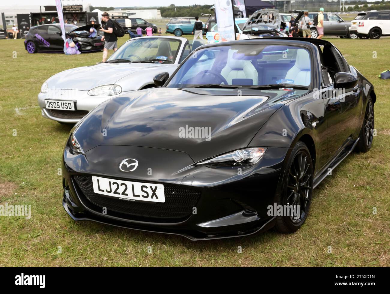 Three-quarters front view of a Black, 2022, Mazda MX-5 ND, RF, GT, on display in the MX-5 Owners ...