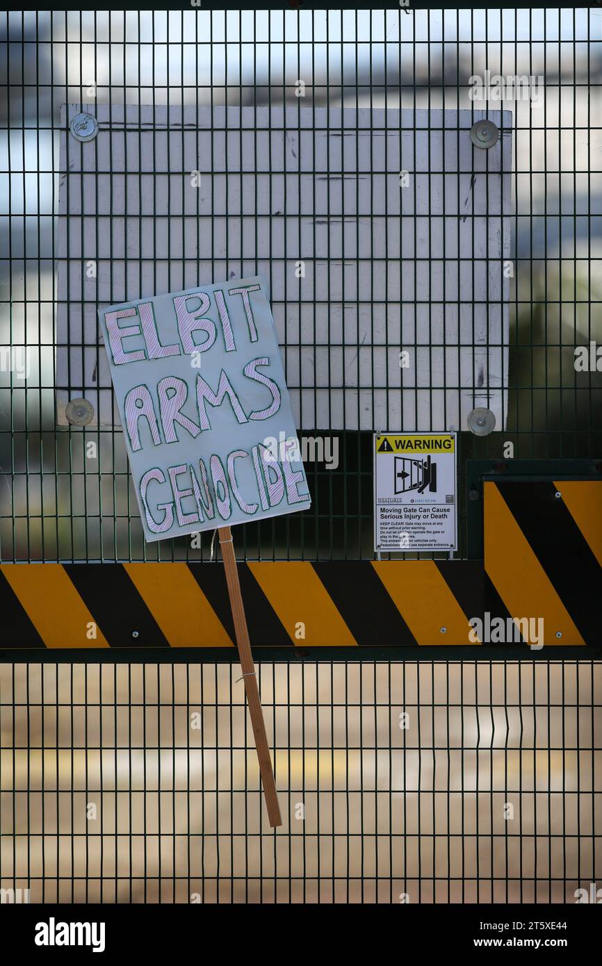 Activists attach a sign to Elbit System's gate that says 'Elbit Arms ...
