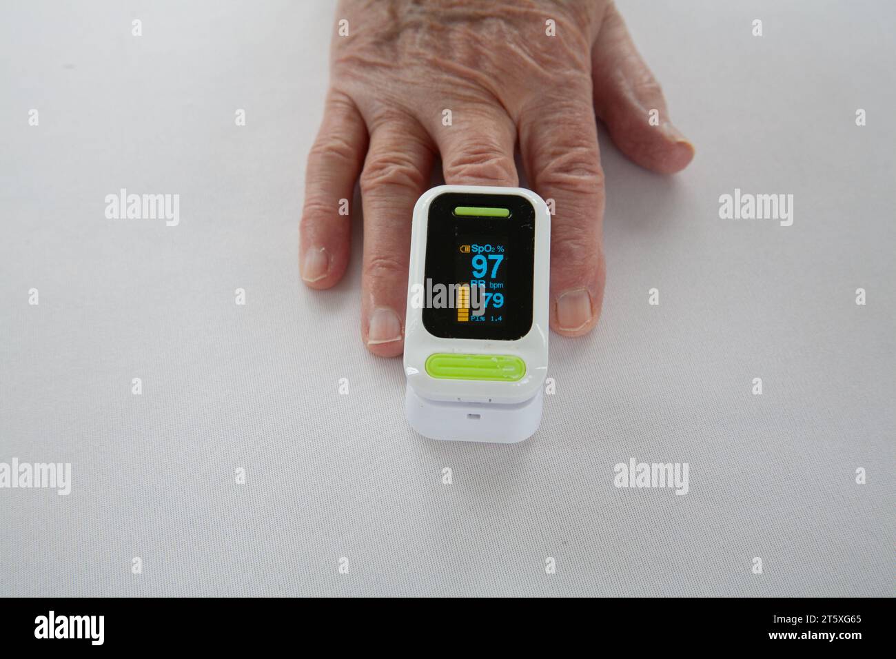 Elderly woman using pulse Oximeter to measure blood oxygen saturation value and pulse rate Stock ...